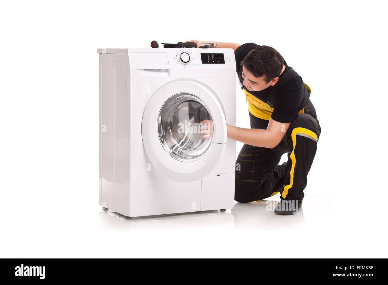 studio photo of washing machine repairman Stock Photo - Alamy