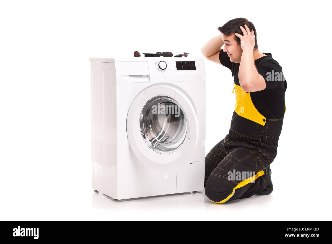 studio photo of washing machine repairman Stock Photo - Alamy