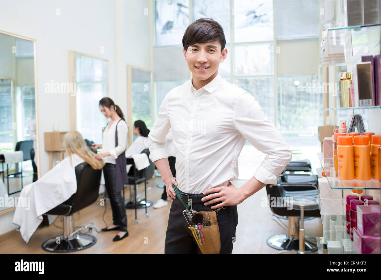 Barbers working in barber shop Stock Photo - Alamy
