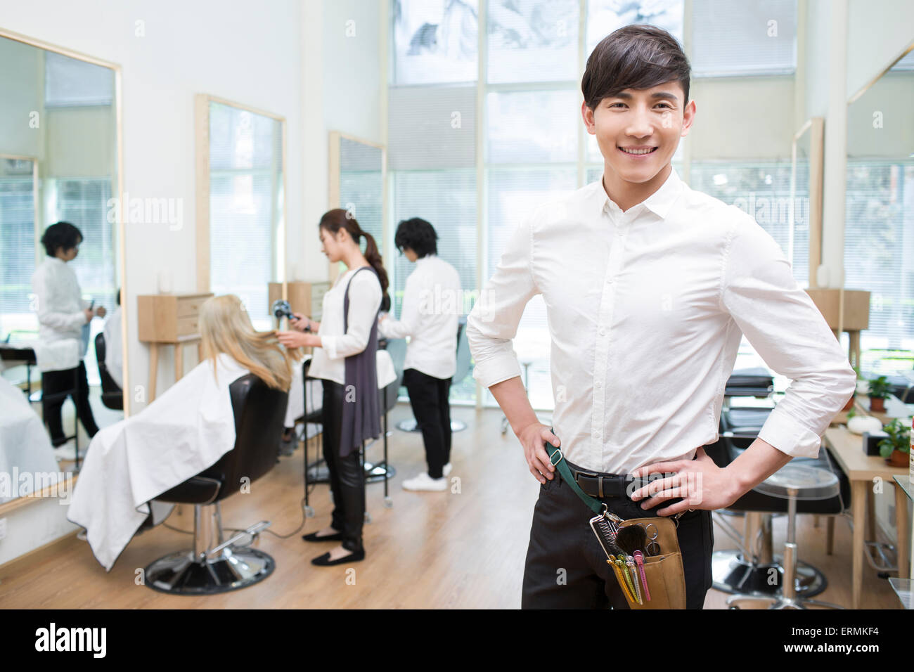Barbers working in barber shop Stock Photo - Alamy