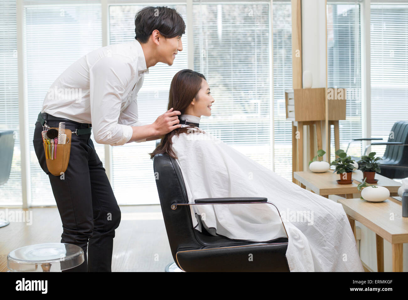 Barber working in barber shop Stock Photo - Alamy