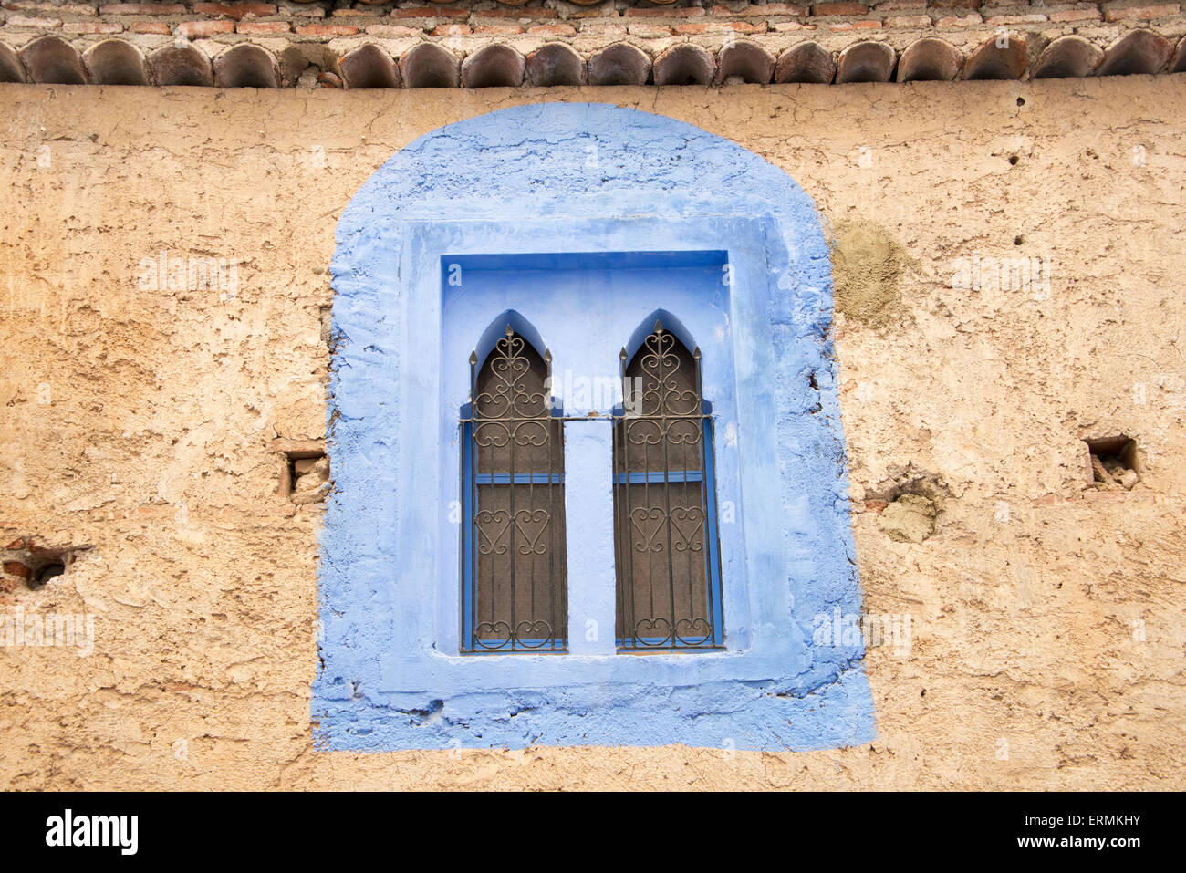 View of blue painted window set in rustic wall; Chefchaouen, Morocco ...