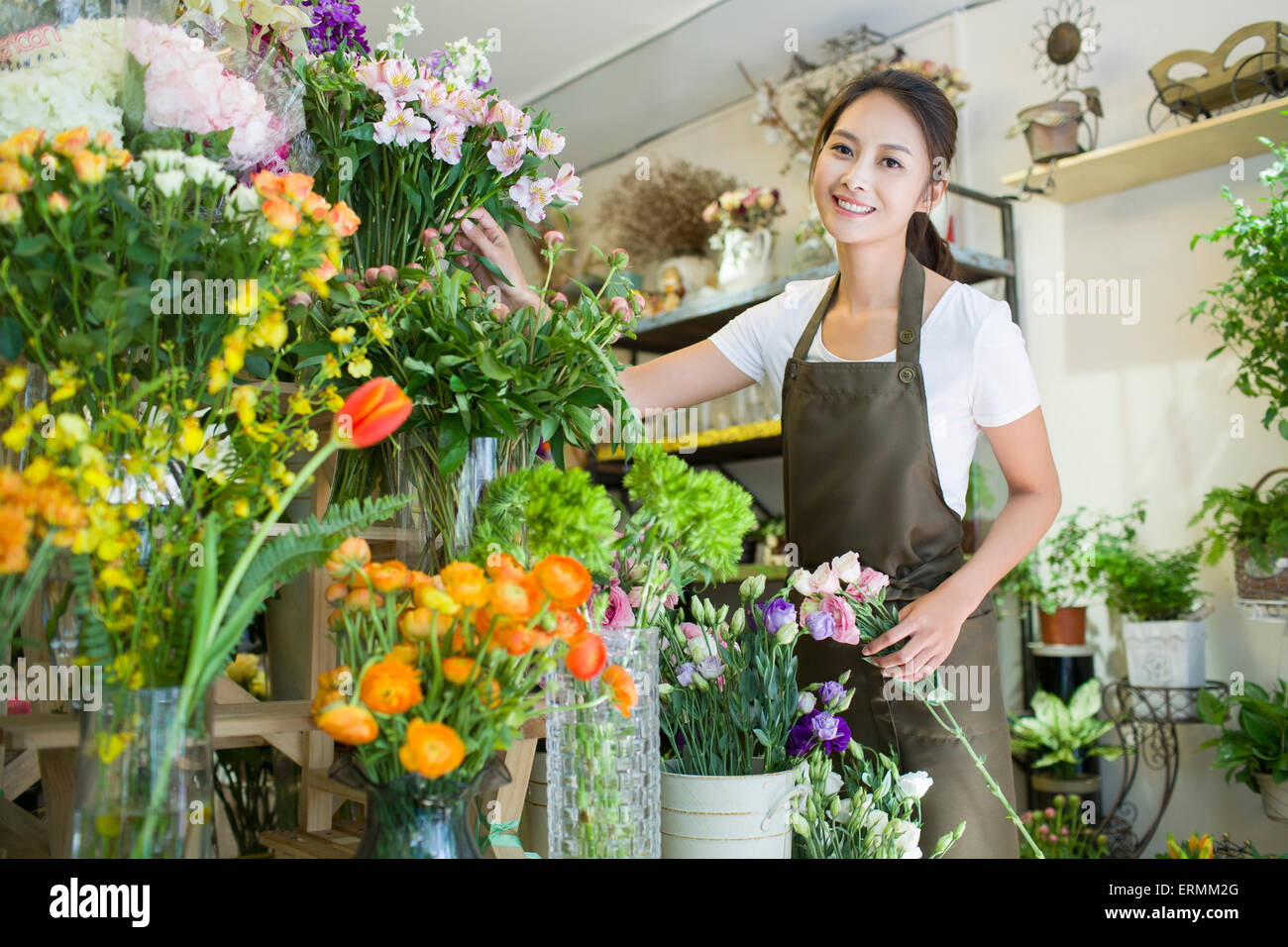 Female florist working in shop Stock Photo - Alamy