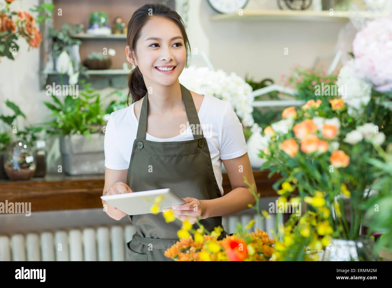 Female florist using digital tablet in shop Stock Photo - Alamy