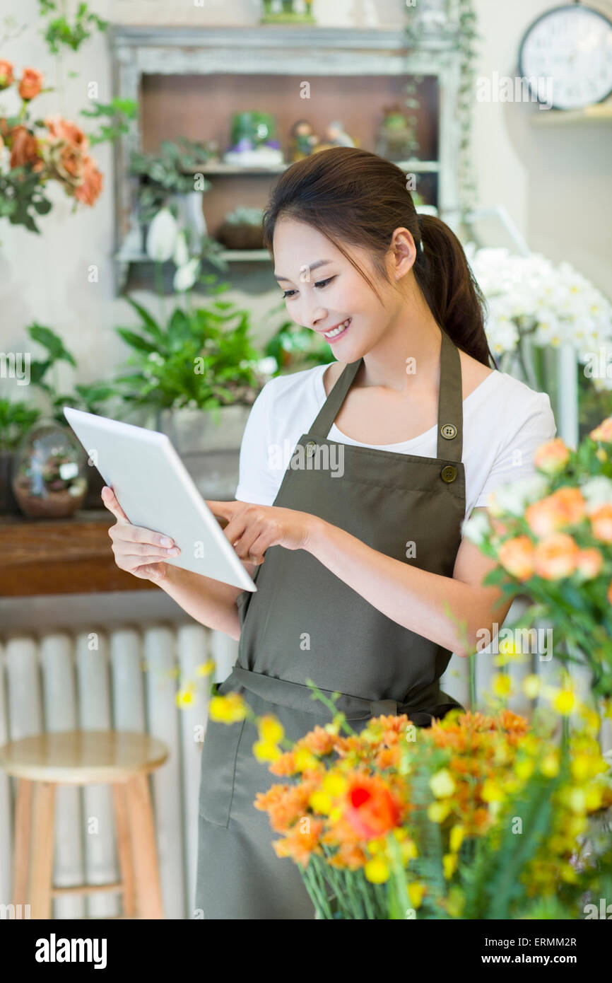 Female florist using digital tablet in shop Stock Photo - Alamy