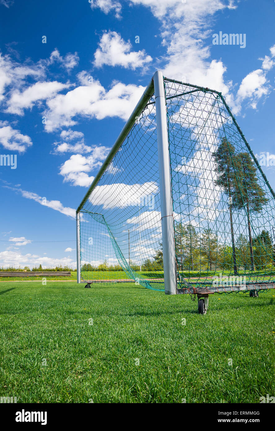Soccer field and empty net against blue sky and white clouds Stock ...
