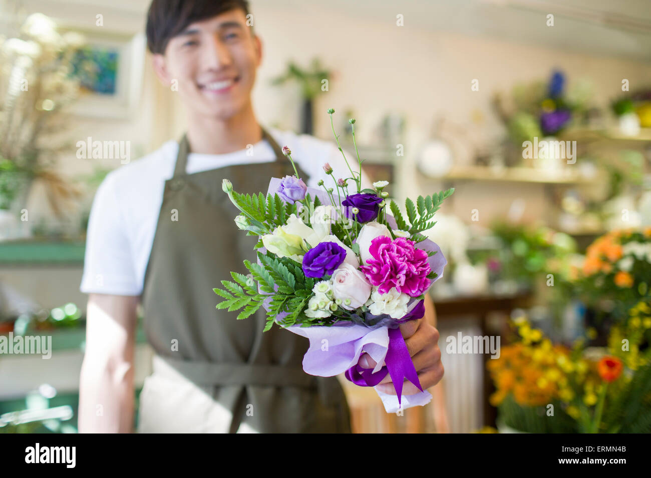 Indian man giving bunch flowers hi-res stock photography and images - Alamy