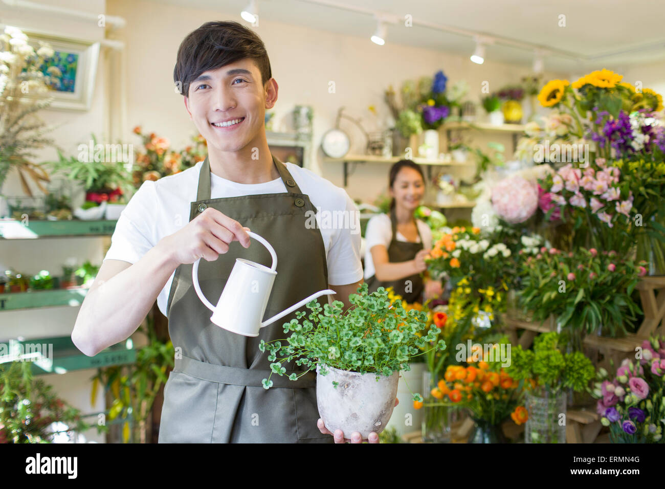 Indian women watering plants hi-res stock photography and images - Alamy