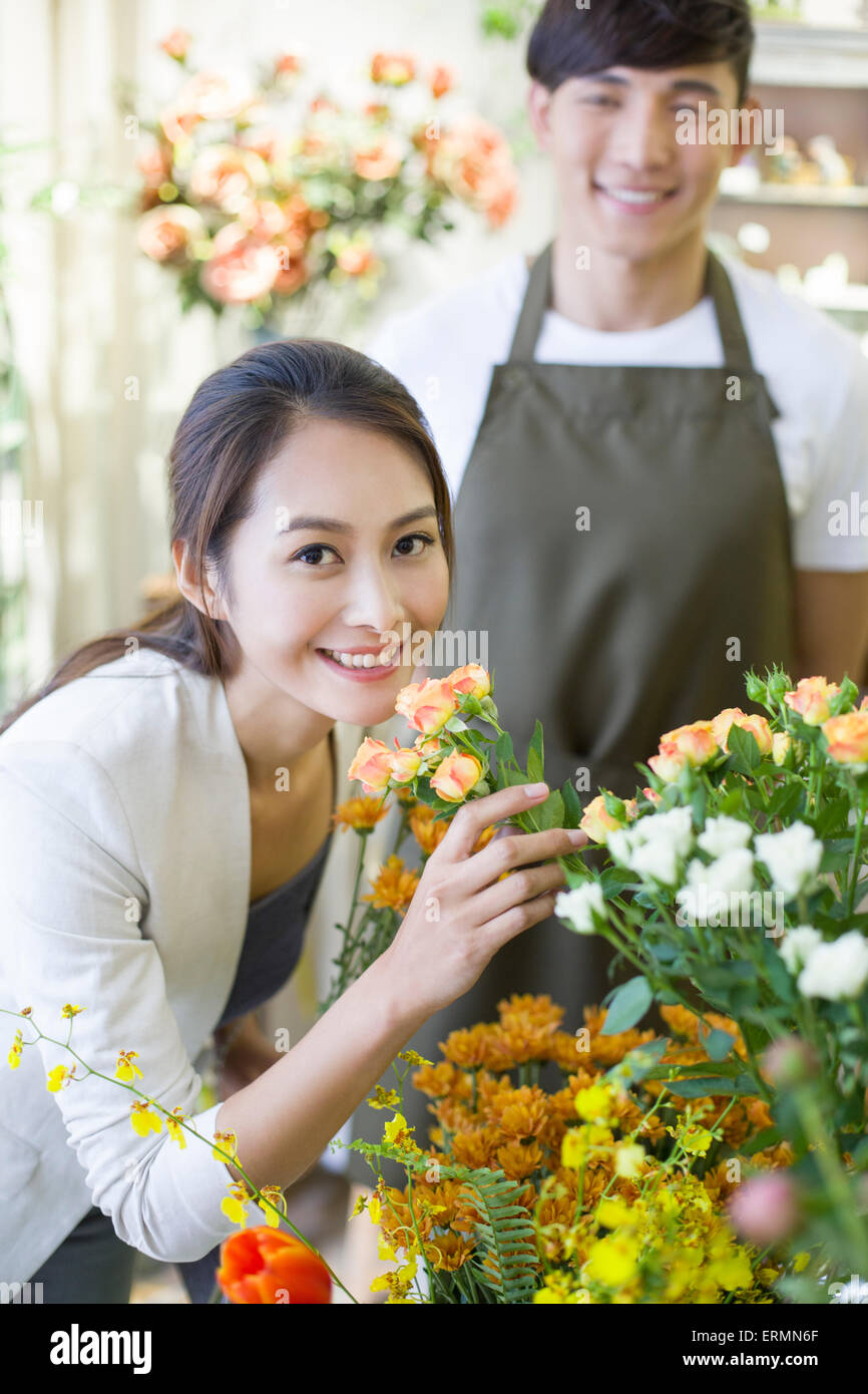 Young woman buying flowers Stock Photo - Alamy