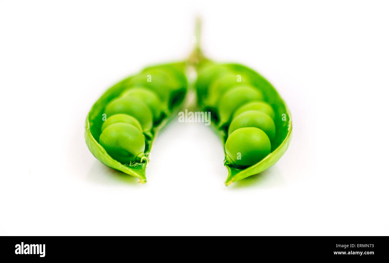 Many raw open pea isolated on white background Stock Photo - Alamy