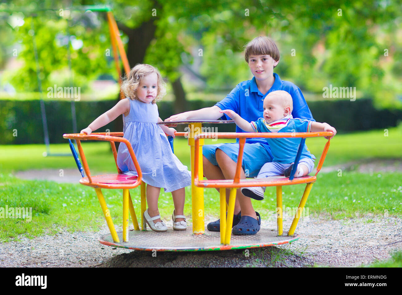 Three happy children, brothers and sister playing together on a ...