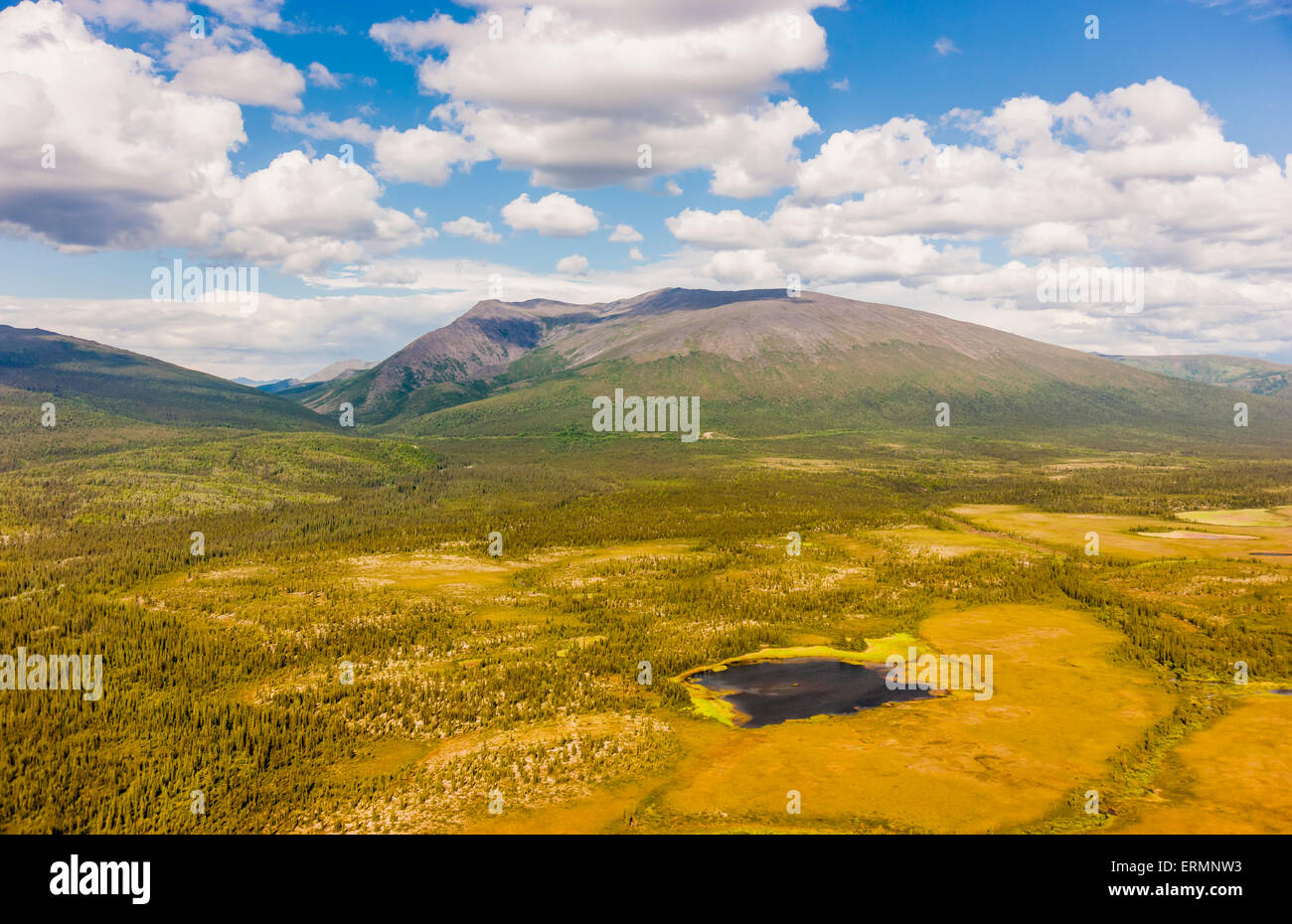 Aerial view of the Baird Mountains, green tundra and a small lake ...