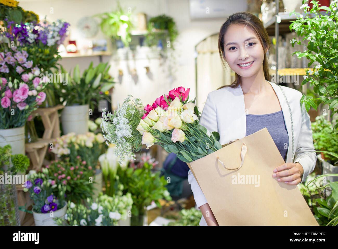 Young woman buying flowers Stock Photo - Alamy