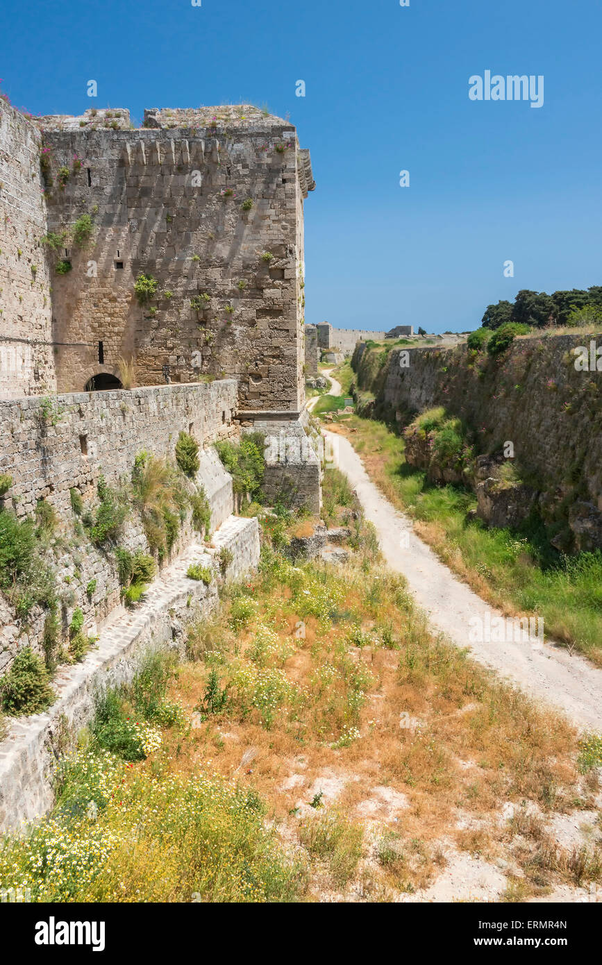 The old medieval castle walls as seen from the moat on the Greek island ...