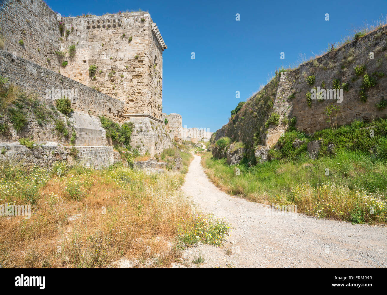The old medieval castle walls as seen from the moat on the Greek island ...