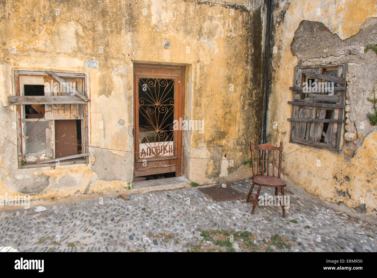 Falling plaster and boarded up windows and doors on a house on the ...