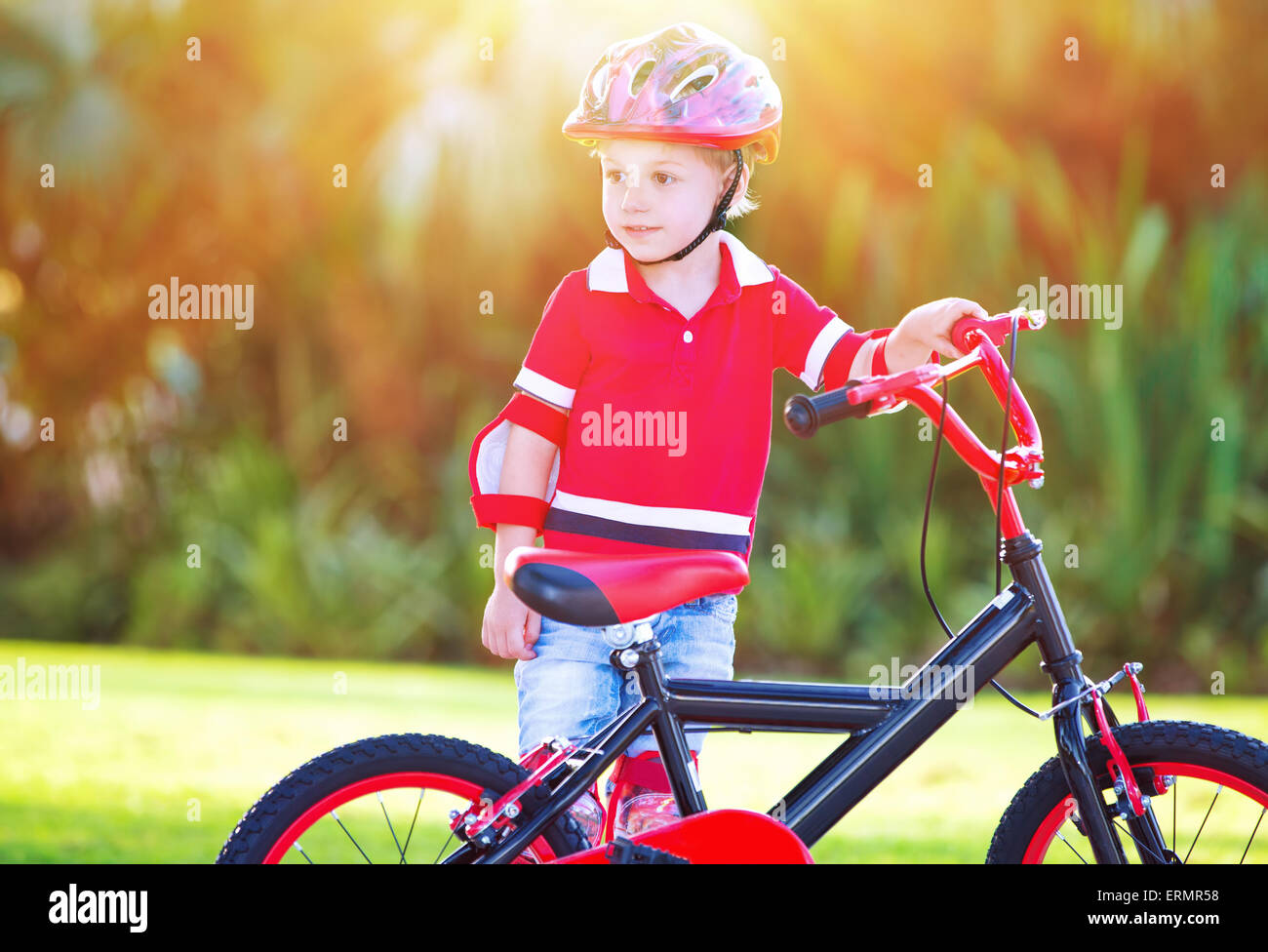 Little boy with bicycle standing outdoor on sunny day, child having fun ...