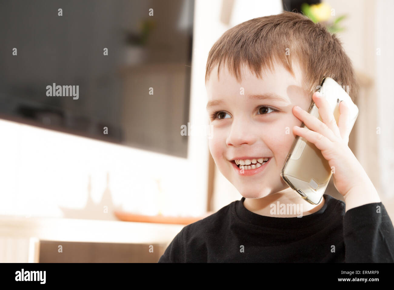 Cute little baby boy is talking on cell phone Stock Photo - Alamy