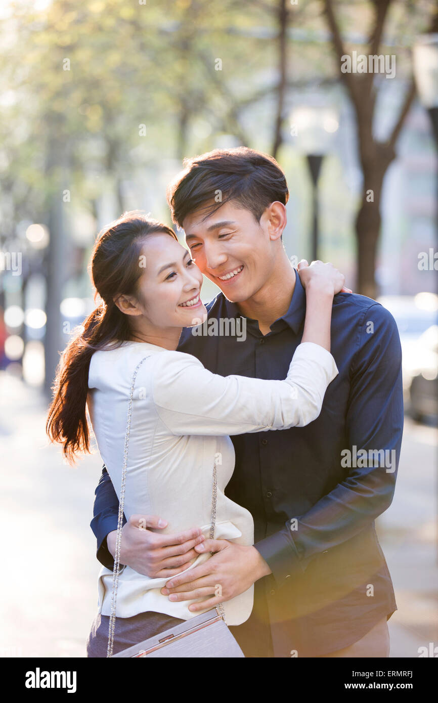 Happy young couple embracing Stock Photo - Alamy