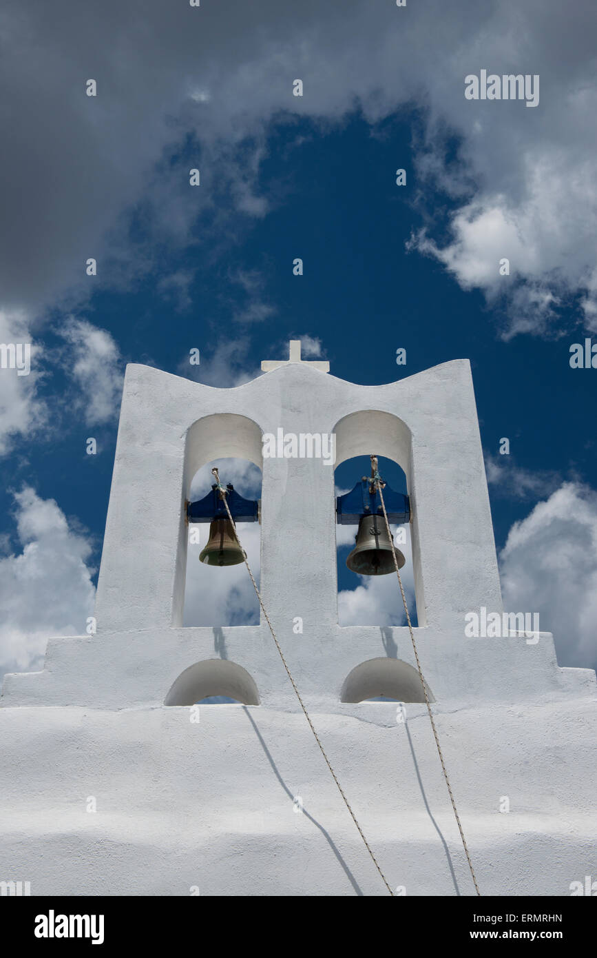 A whitewashed bell tower and dramatic white clouds; Sifnos, Cyclades ...