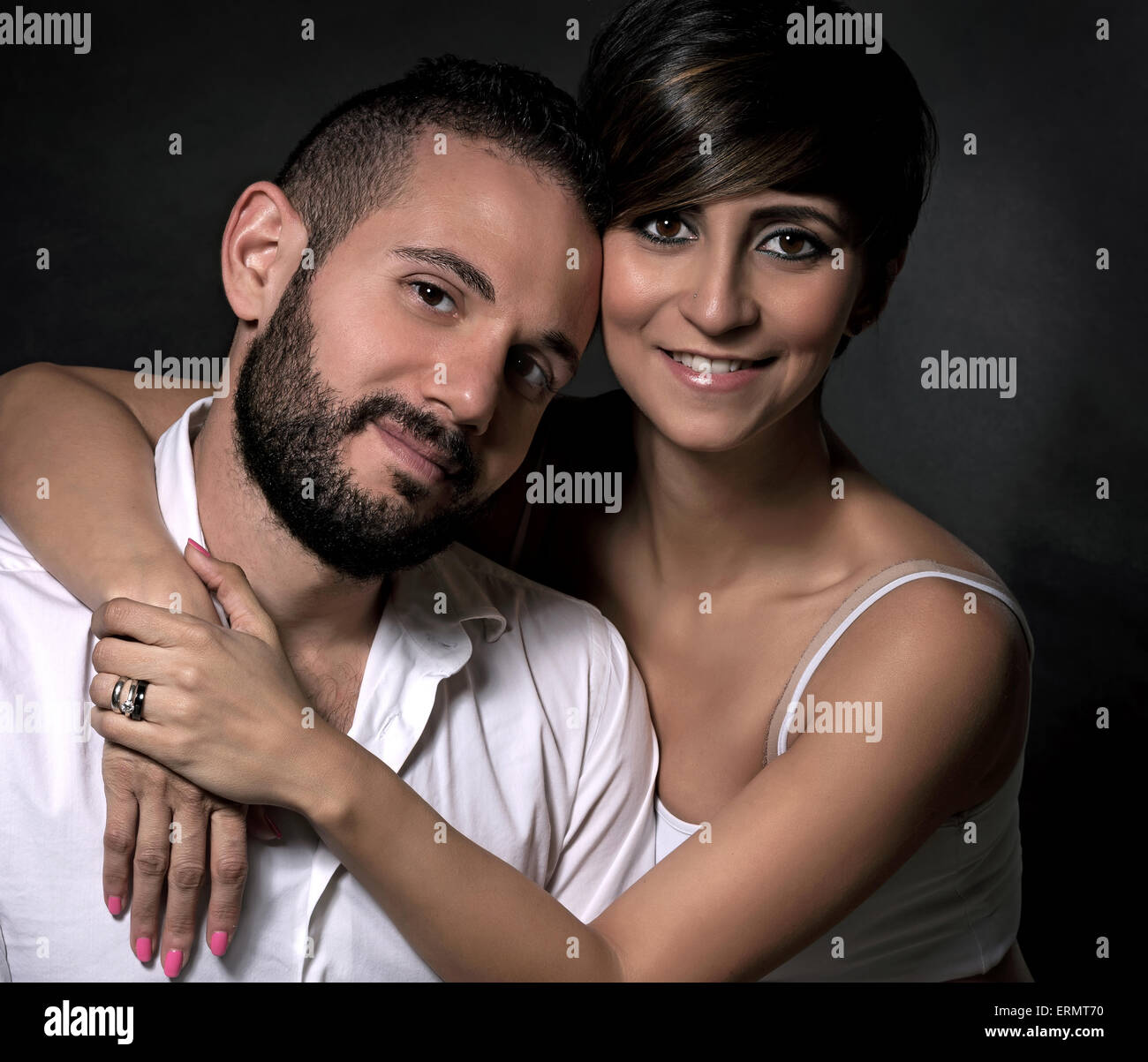 Portrait of beautiful gentle lovely couple over black background ...
