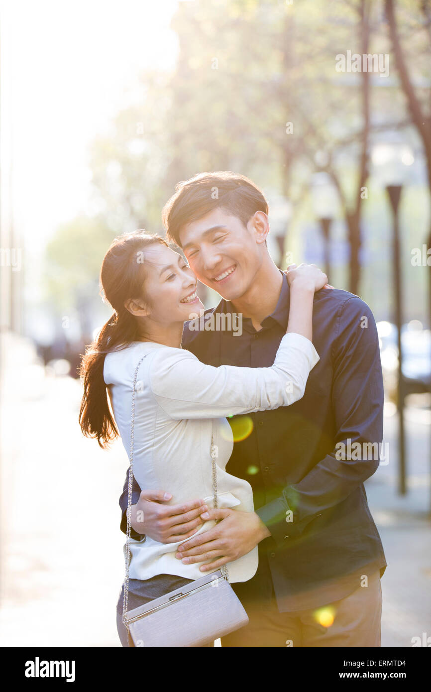 Happy young couple embracing Stock Photo - Alamy