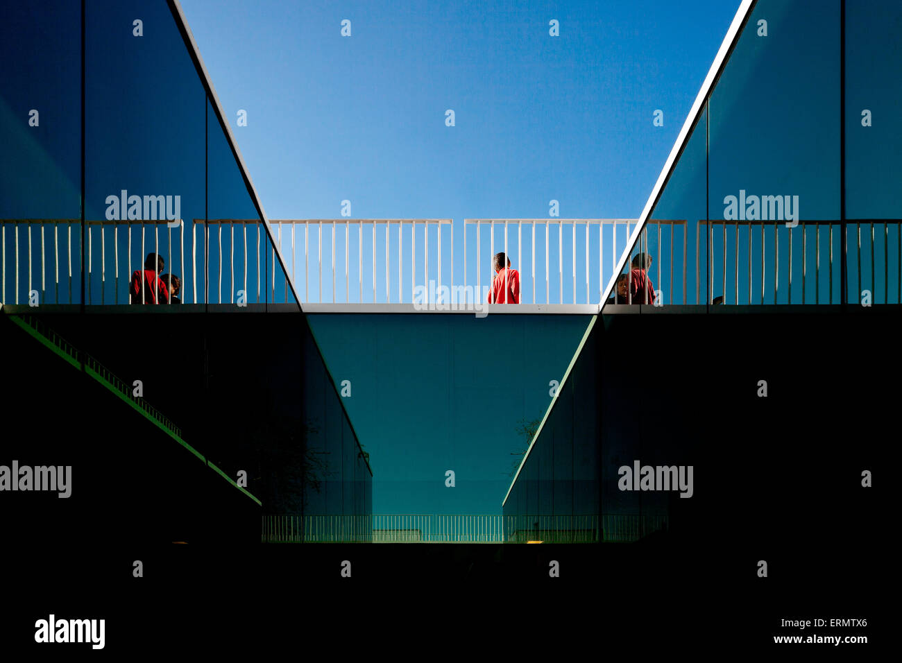 Facade glazing and reflection with passing figure. Center School S ...