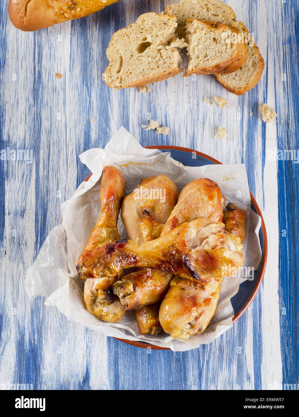 Roasted chicken legs with fresh bread. Top view Stock Photo - Alamy