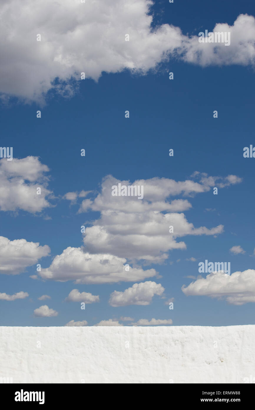 Wall of snow with puffy clouds and blue sky above, Park City, Utah, USA ...