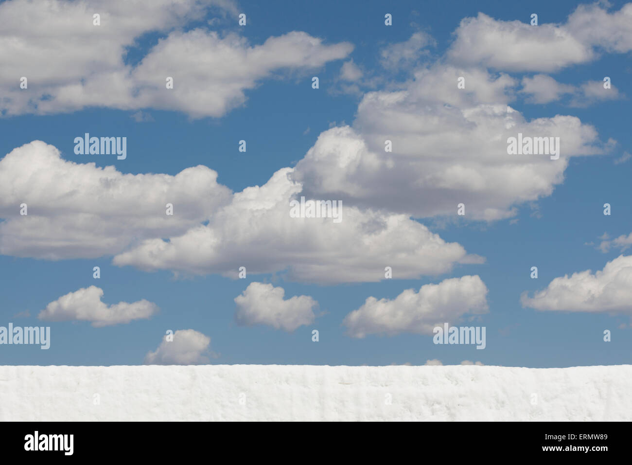 Wall of snow with puffy clouds and blue sky above, Park City, Utah, USA ...