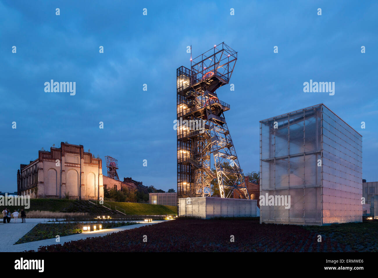 Modern glass cube in juxtaposition with historic mining tower and ...