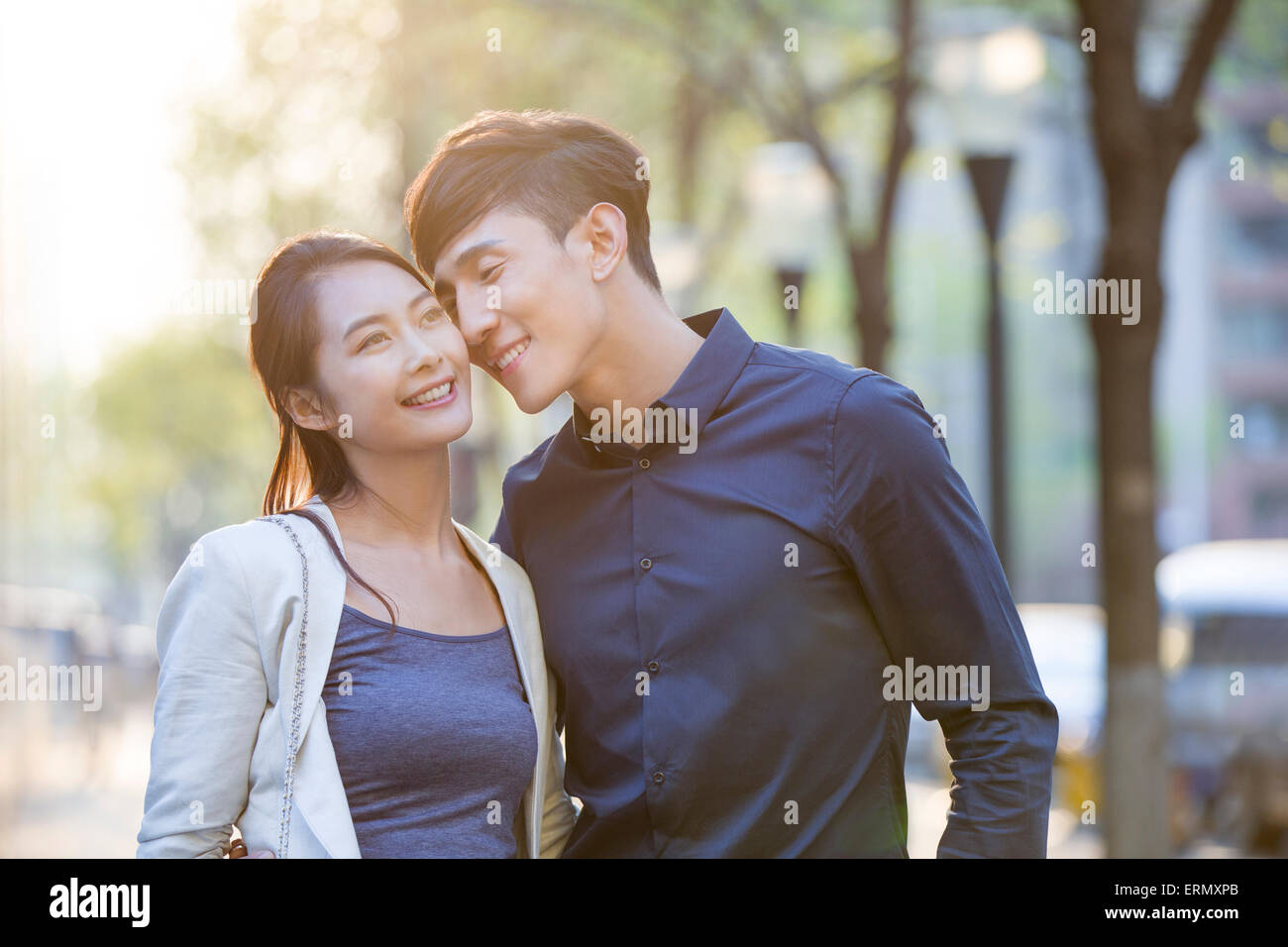 Happy young couple embracing Stock Photo - Alamy