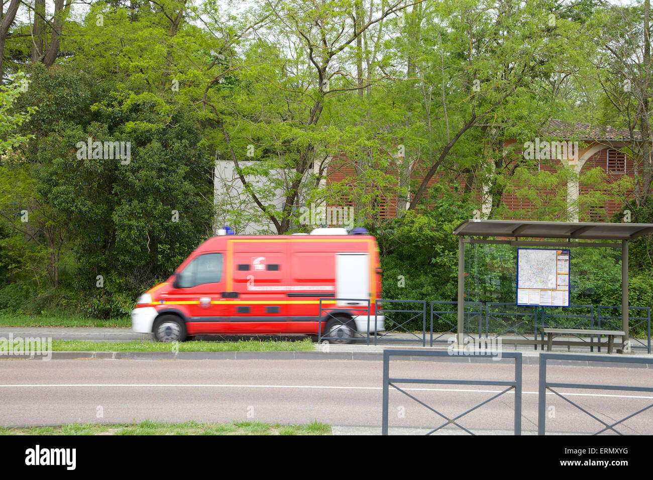 Red ambulance running on a road in town with motion effect Stock Photo ...