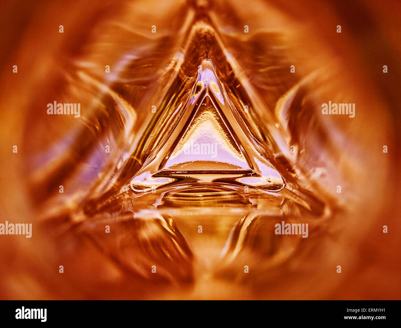 Abstract image of the inside of a triangle glass bottle red color ...