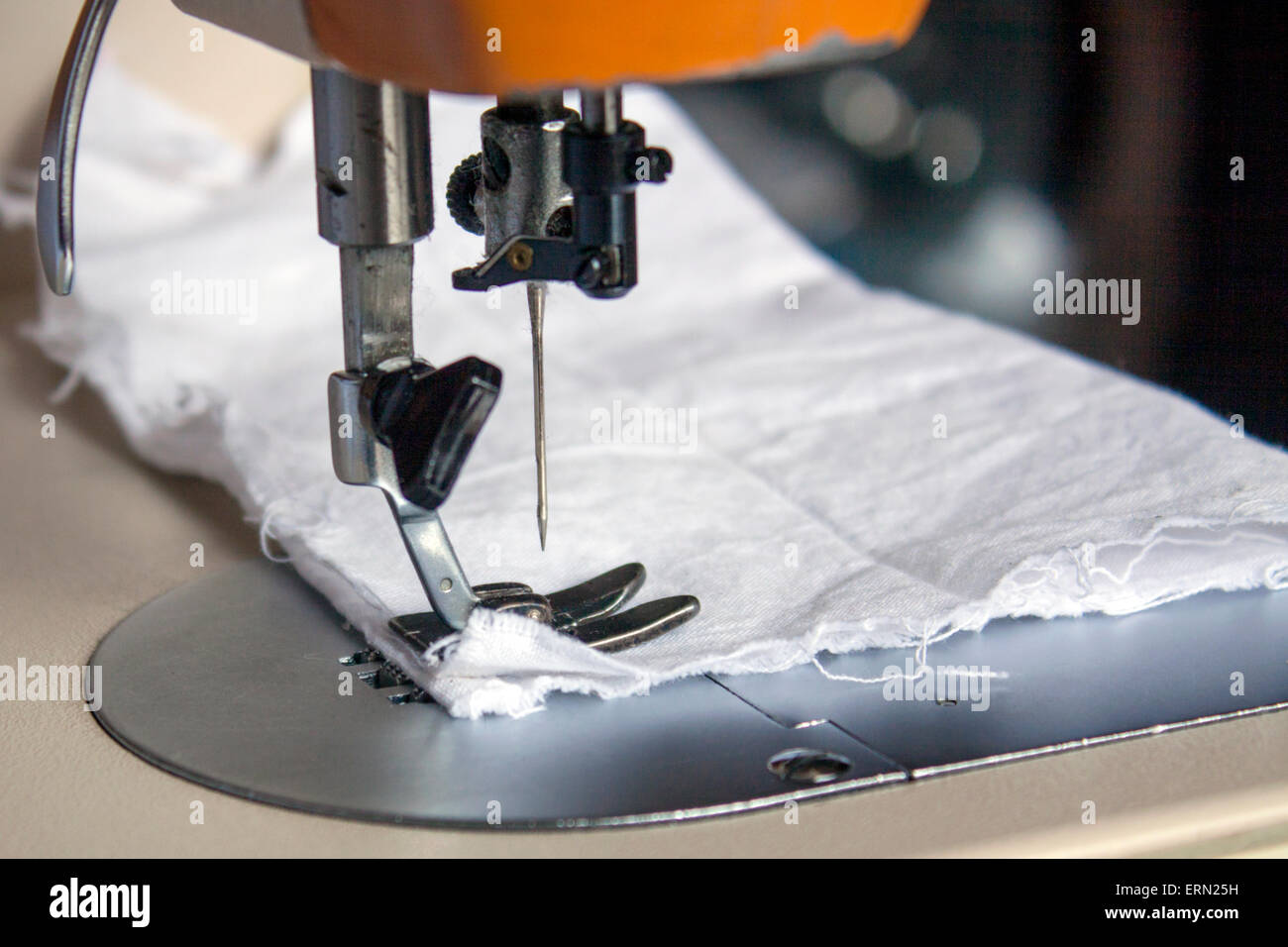a closeup view of a sewing machine with a piece of cloth Stock Photo ...