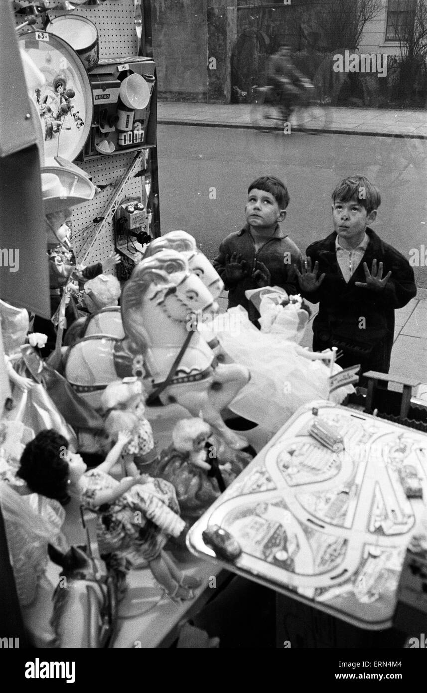 Children look longingly at toys into shop window at Christmas, 16th ...