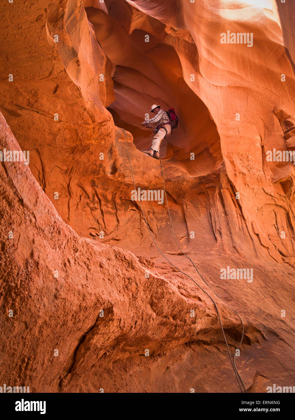 Adventurer exploring a desert slot canyon; Hanksville, Utah, United ...
