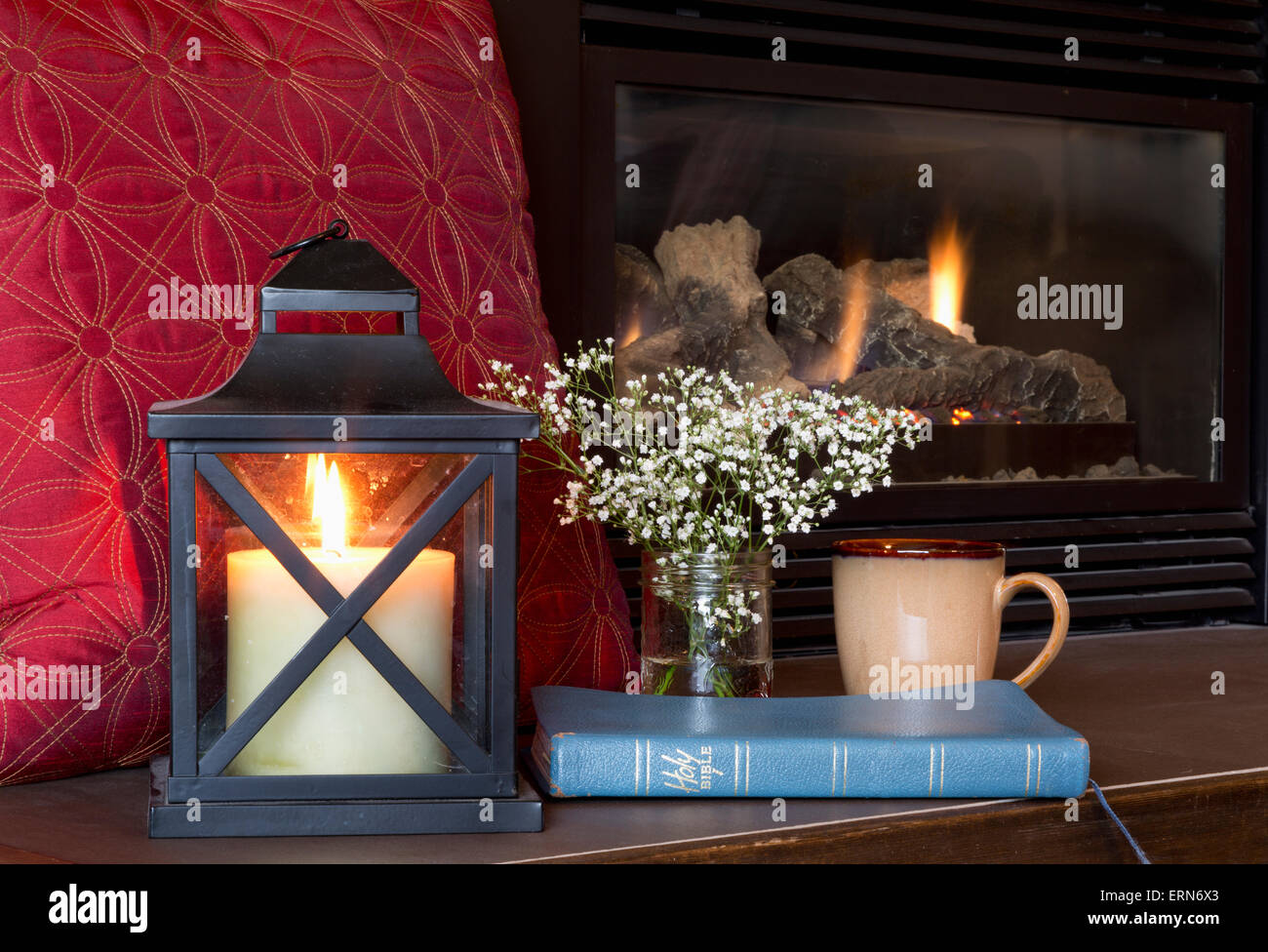 A Bible, candle and mug sit on the fireplace hearth; Yarrow, British ...