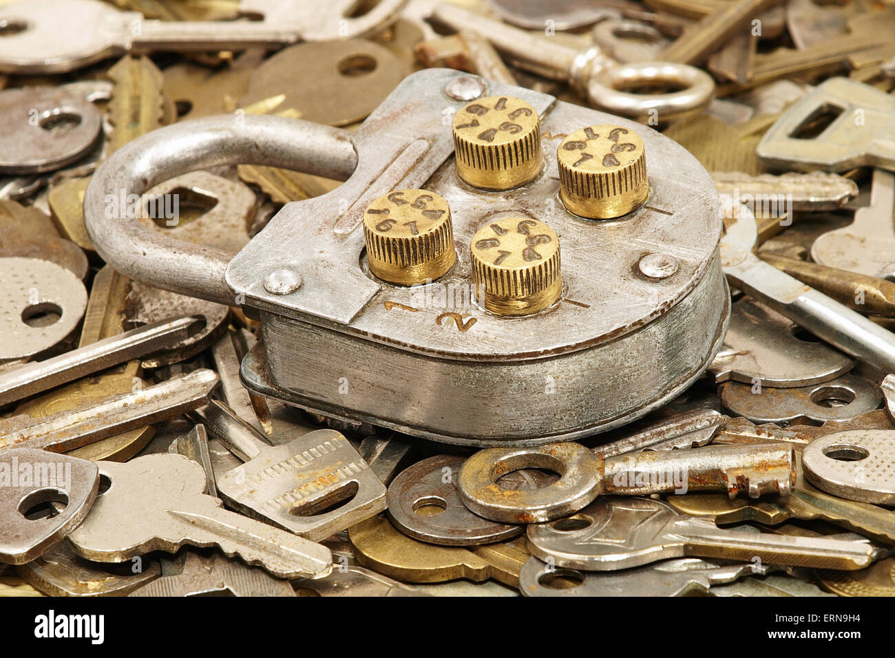 Metal old lock on a lot keys background Stock Photo - Alamy