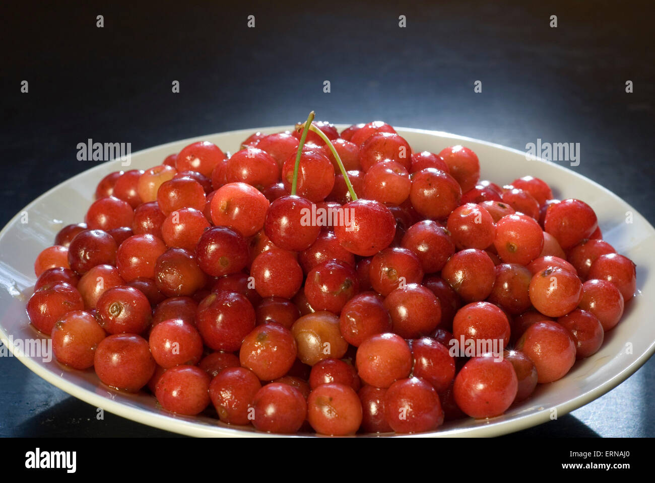 A bowl of small red cherries Stock Photo - Alamy