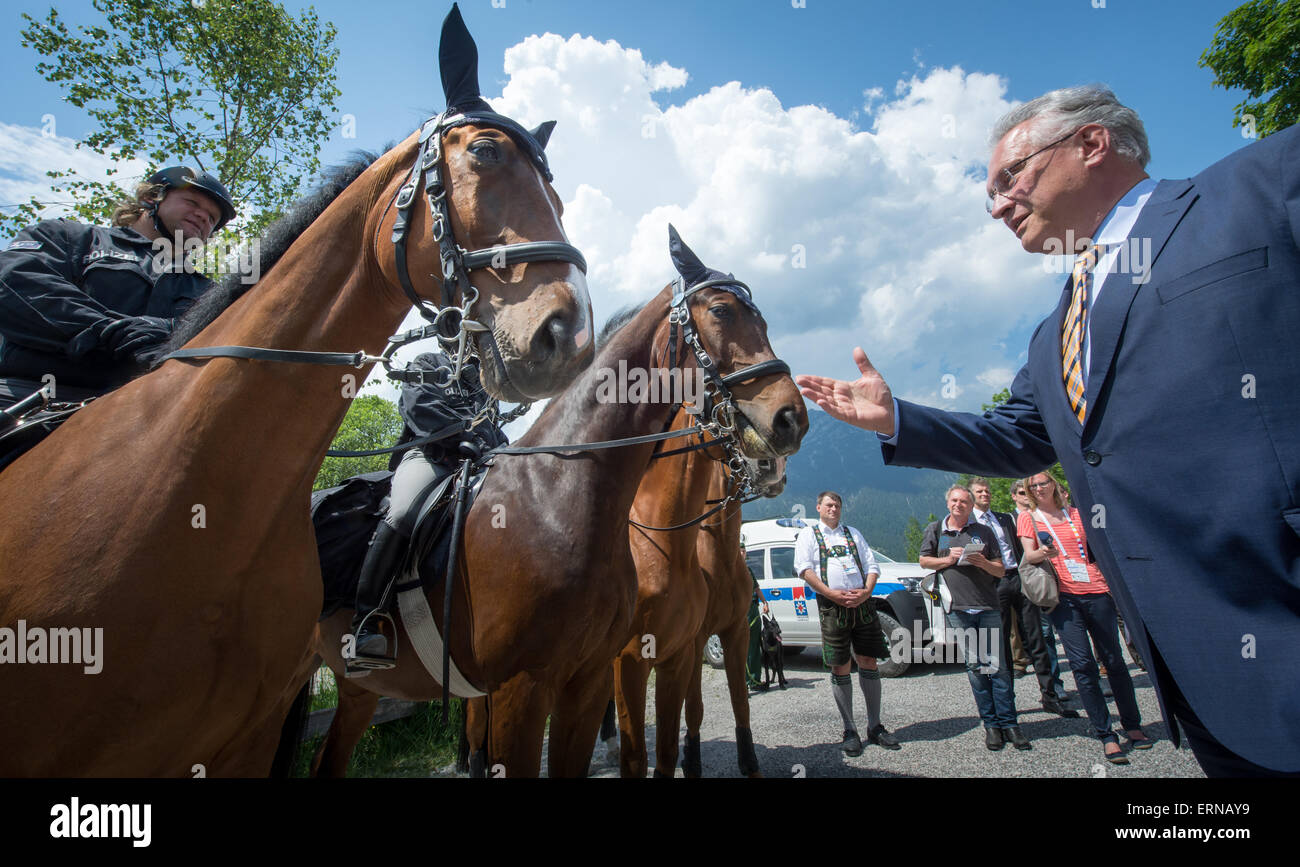 Bavarian Minister of the Interior Joachim Herrmann speaks with officers ...