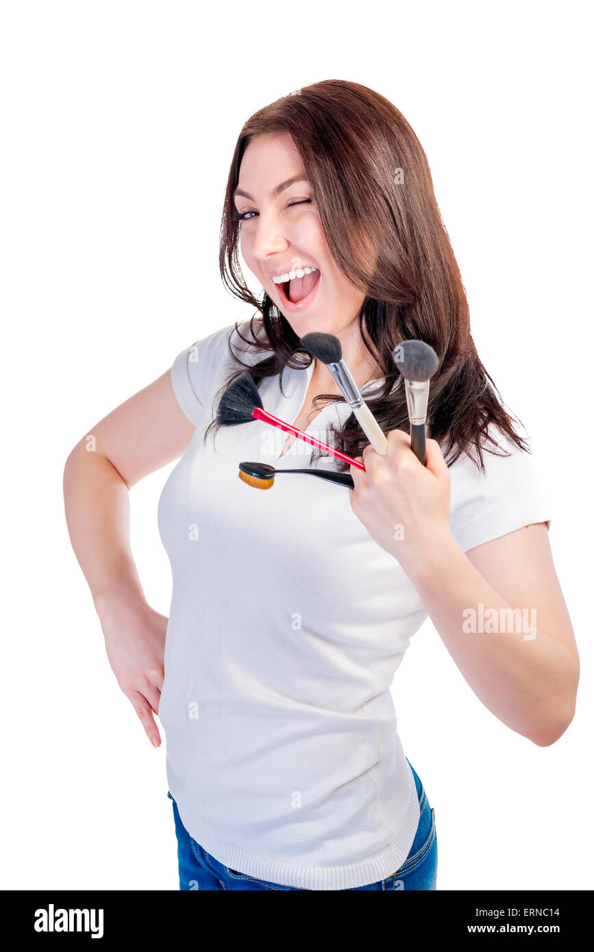 cheerful girl with brushes for make-up winks Stock Photo - Alamy