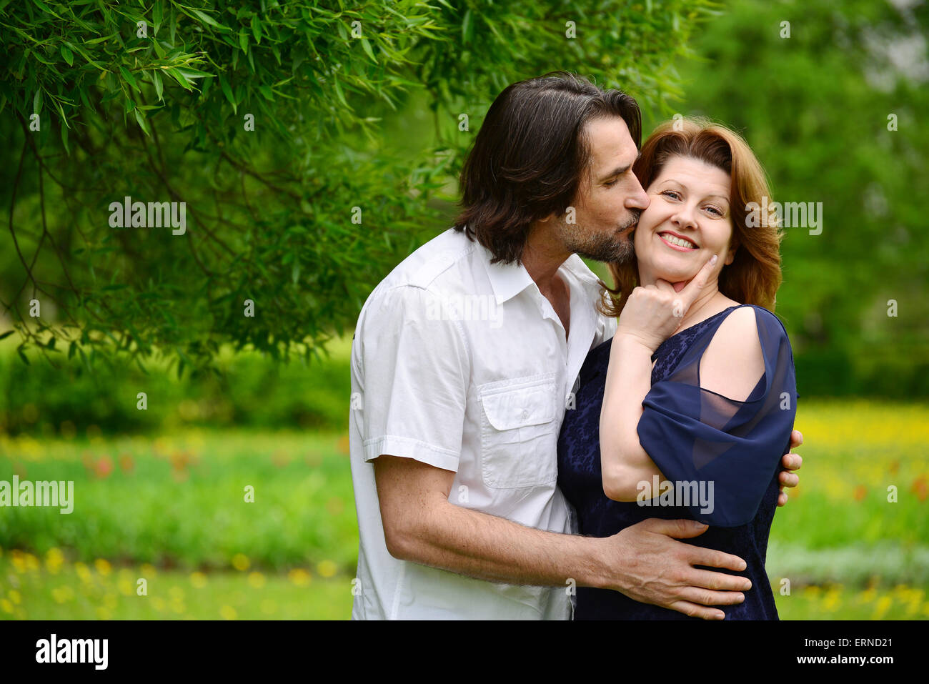Adult male and female in a park in spring Stock Photo - Alamy