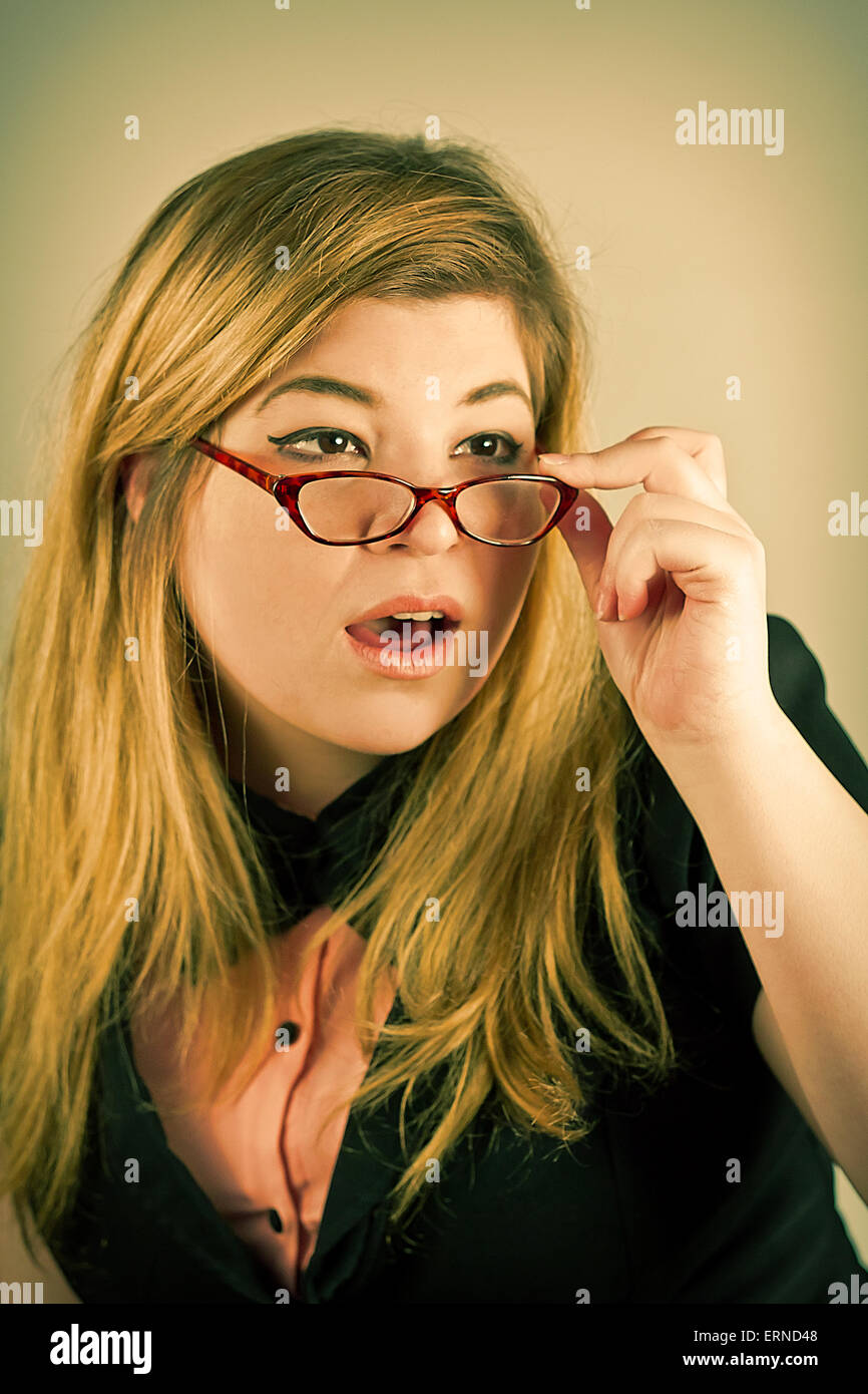 Cute nerdy girl with reading glasses posing for a portrait Stock Photo ...