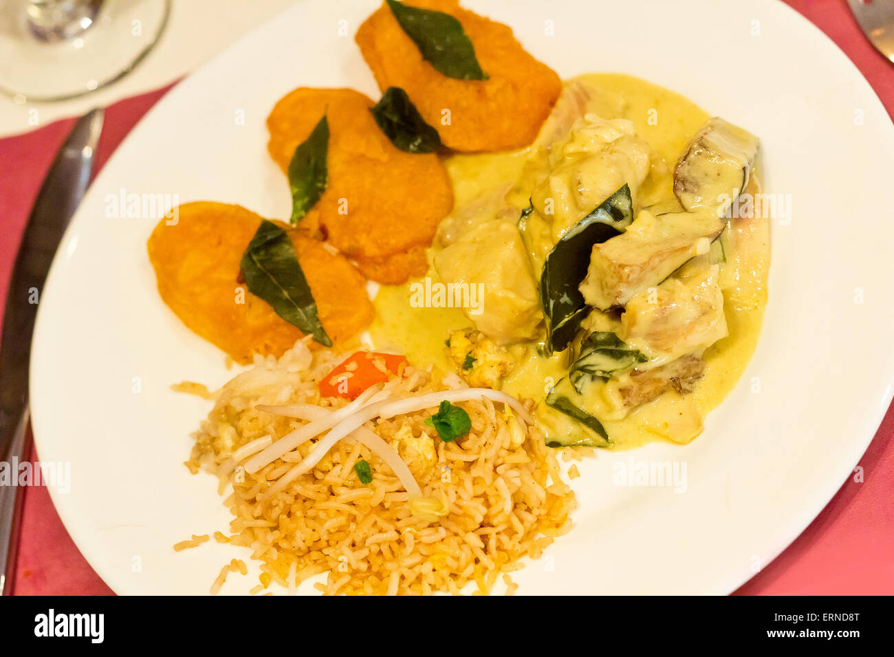 Green fish curry with side of vegetable pakora and fried rice Stock ...