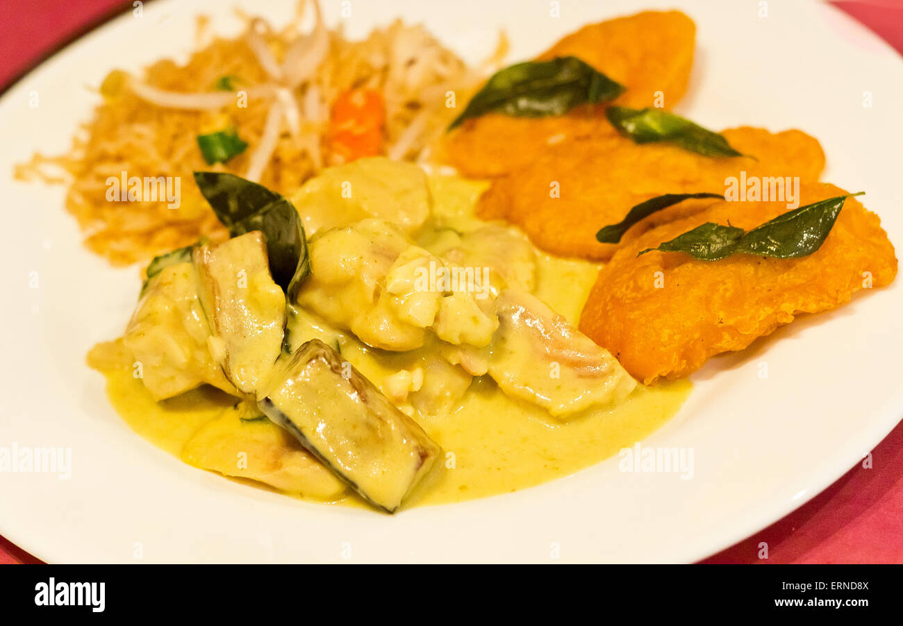 Green fish curry with side of vegetable pakora and fried rice Stock ...