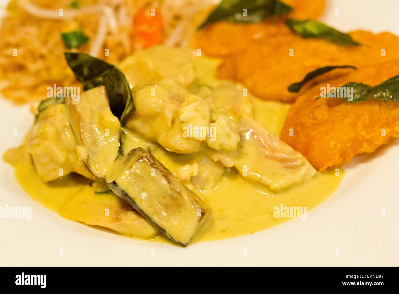 Green fish curry with side of vegetable pakora and fried rice Stock ...
