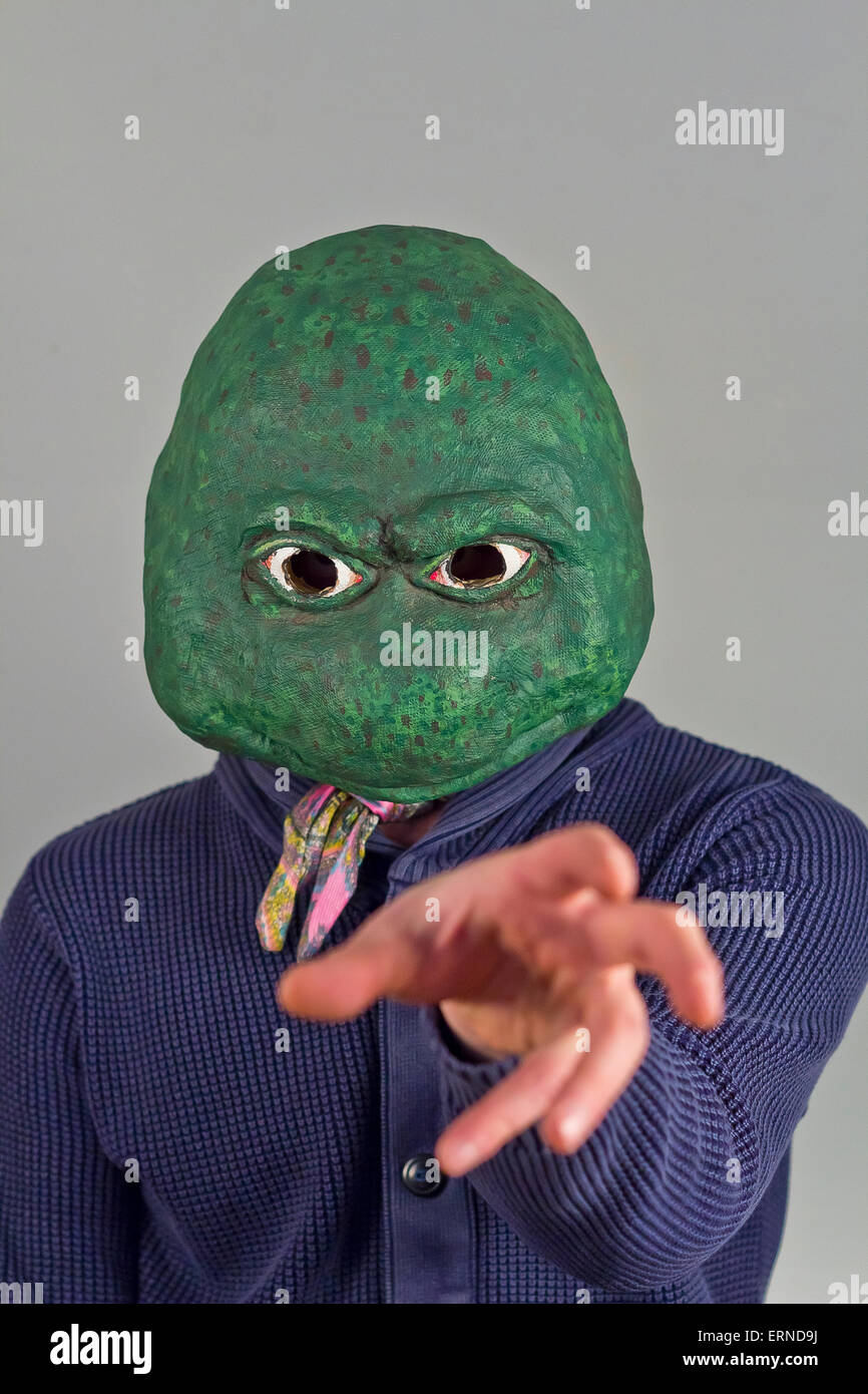 Creepy bald lizard man wearing a blue sweater Stock Photo - Alamy