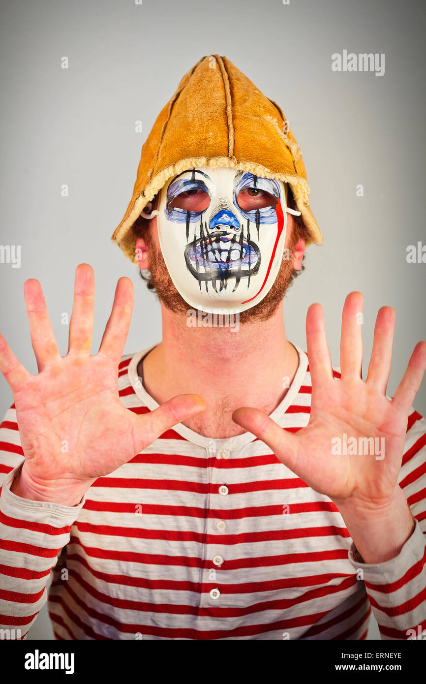 Weird scary masked mime in striped red and white shirt Stock Photo - Alamy