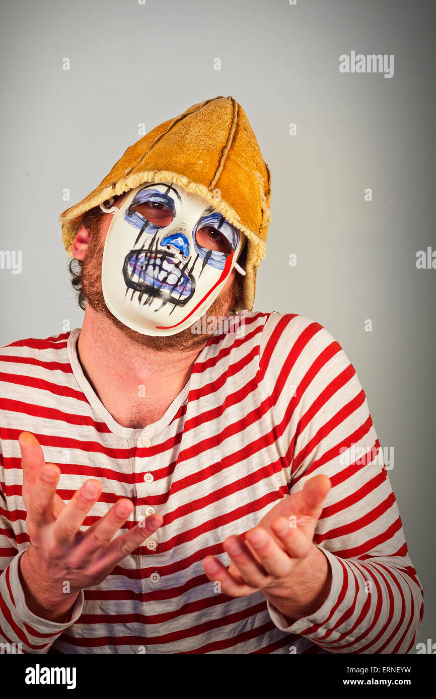 Weird scary masked mime in striped red and white shirt Stock Photo - Alamy